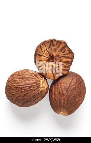 Three nutmeg and powder isolated on white background Stock Photo - Alamy