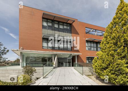 Terracotta brick and black metal facade of office building with a ...