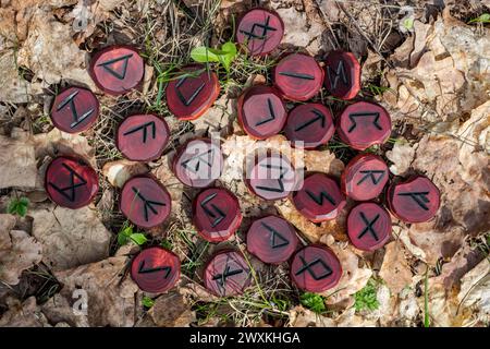 Red runes carved from wood on the ground Stock Photo - Alamy