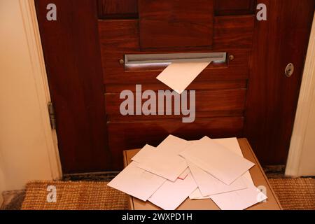 Wooden door with mail slot, many envelopes and cardboard indoors Stock ...