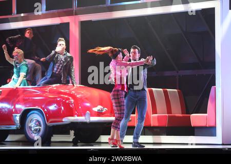 The cast of the musical Grease perform live on stage at West End Live ...