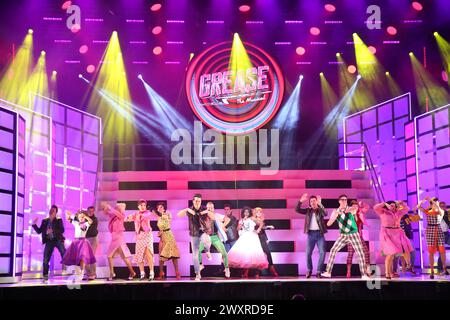 The cast of the musical Grease perform live on stage at West End Live ...