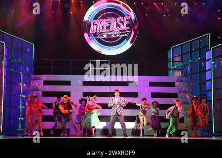 The cast of the musical Grease perform live on stage at West End Live ...