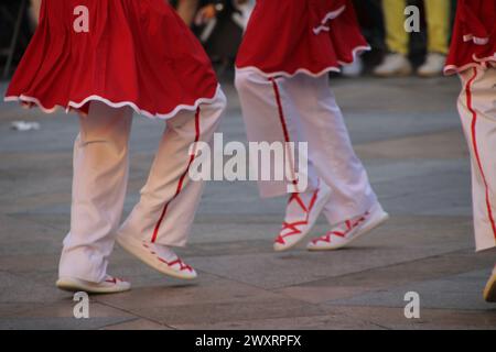 A diverse group of Basque folk dancers during a festival in the street ...
