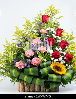 A closeup of a tropical bouquet with roses on a table Stock Photo - Alamy