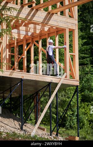 A construction worker, donning a hard hat, safety goggles, and a ...