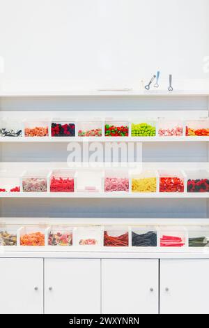 showcase of candy shop, transparent container with various sweets ...