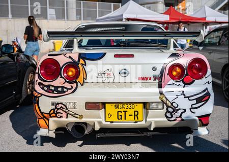 Rear view of a tenth generation Nissan Skyline GT R34 with some vinyls ...