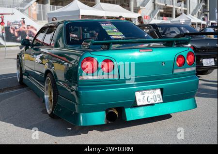 Rear view of a tenth generation Nissan Skyline GT R34 with some vinyls ...