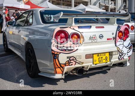 Rear view of a tenth generation Nissan Skyline GT R34 with some vinyls ...