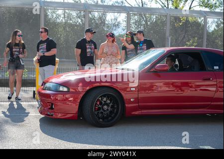 Front view of a red ninth-generation Nissan Skyline GT-R33 at a ...