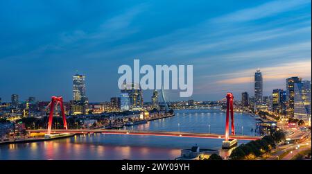 Sky line of Rotterdam at night over the river Maas showing the Willems ...
