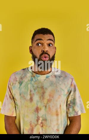Amazed confused man with raised eyebrows covering mouth with hand ...