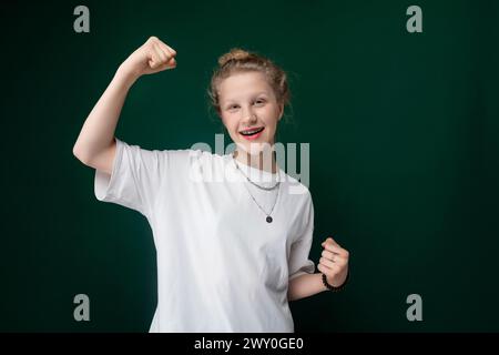 A woman poses with determination and strength, her fist raised high ...
