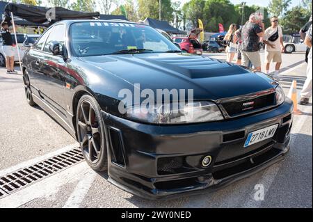 Front view of a black Nissan GT-R35 with a carbon fiber body kit at a ...