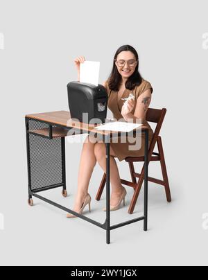 Secretary destroying document in shredder on lilac background Stock ...