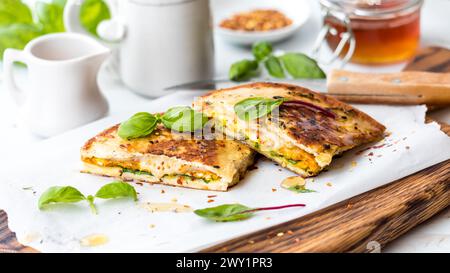 Egg and melted gouda cheese naan bread breakfast sandwiches Stock Photo ...