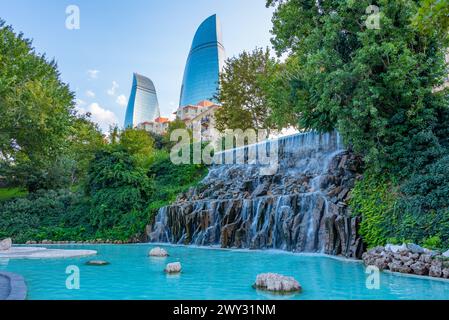 Flame towers viewed behind waterfall at selale park in Baku, Azerbaijan ...