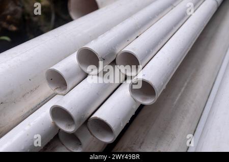 White PVC pipes ready to be installed to a new construction project ...