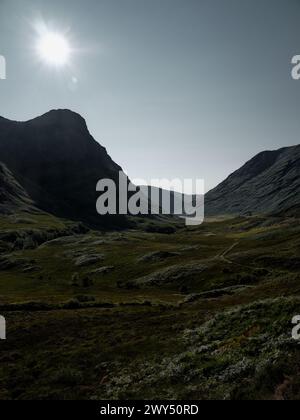 The dark backlit summer landscape of Glencoe Highlands Scotland UK ...