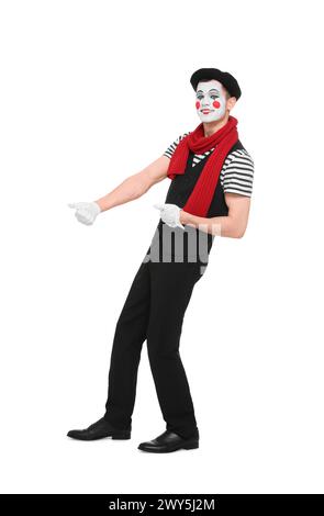 Funny mime artist in beret pointing at something on white background ...