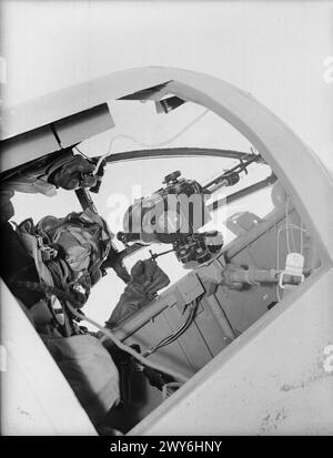 A bomb aimer operates a Mark IXA Course-setting Bombsight in the nose ...