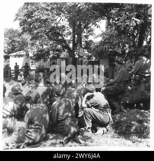 GEORGE FORMBY ENTERTAINED TROOPS IN NORMANDY - George Formby standing on a jeep entertaining the ...
