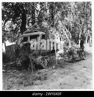 ADVANCE BEYOND MONT PINCON - A knocked out German tank in the village ...