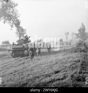 Sherman Crab flail tanks advance through a village toward Tilly-sur ...