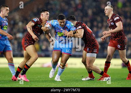Wigan Warriors' Patrick Mago (centre) lifts the trophy with team-mates ...