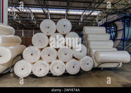 Packs of rolled foam rubber in warehouse Stock Photo - Alamy