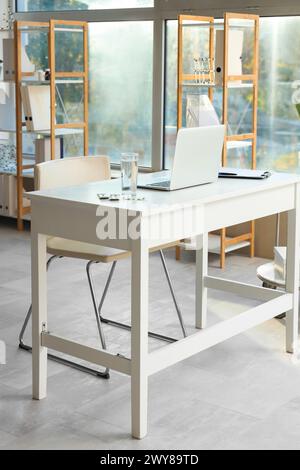 Interior of office with workplace and shelf units Stock Photo - Alamy