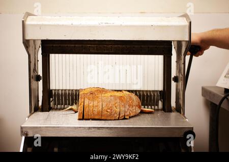 Bread slicing machine. Sliced bread on the production line of food and bakery products Stock ...
