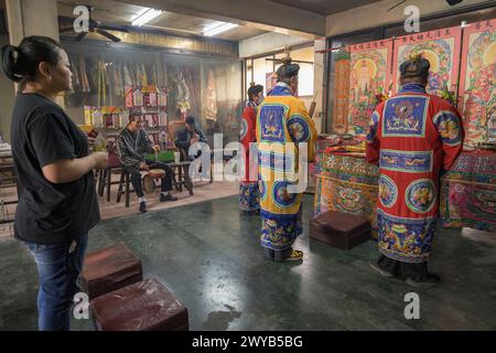 A traditional shaman performing a ritual with offerings to the ...