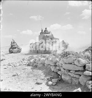 British Army cruiser tanks move in line ahead formation over hilly ...