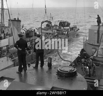 NAVY OPERATION: BRITISH BATTLESHIP REFUELS DESTROYER AT SEA. 6 FEBRUARY ...