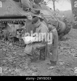 A British Army Sherman tank crewman navigates heavy mud conditions in ...