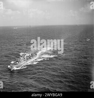 HMS Mauritius, a cruiser, and HMS Nizam, a destroyer, operate at sea at ...