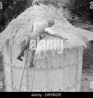 A farmer at Mount Barton Farm in Devon, England, loads milk churns onto ...