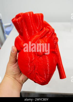 Hand holding a human figure on a white background Stock Photo - Alamy