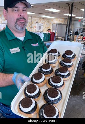 Special OREO donuts are displayed by an employee at a Krispy Kreme ...