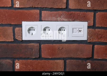 Electric power sockets on brick wall indoors Stock Photo - Alamy