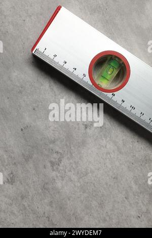 Aluminium building level on grey table. Space for text Stock Photo - Alamy