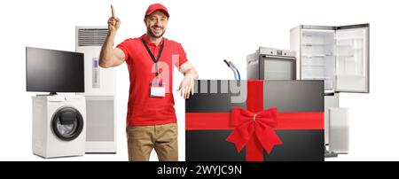 Salesman pointing at a flat lcd tv screen and other home appliances ...