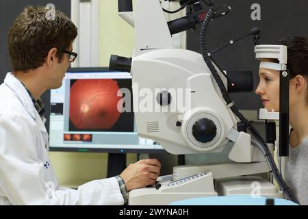 Eye examination Doctor using a retinal camera during an angiography ...