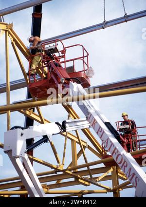 Steel frame construction operations for supermarket development, crane ...