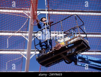 Installing safety netting from high level access platform prior to ...