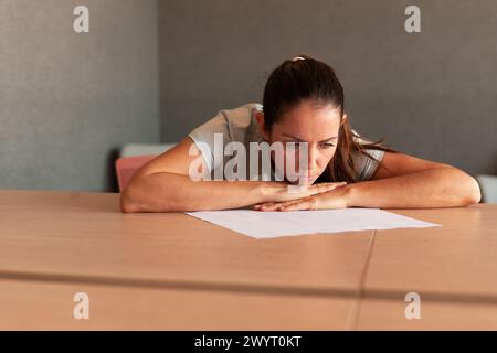 Frustrated student trying to learn reading notes sitting in the street ...