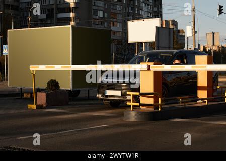Car approaching to automatic barrier gates for supermarket parking lot ...