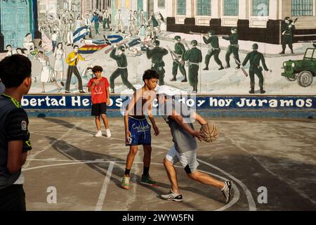 Basketball game in front of wall murals depicting the history of León ...